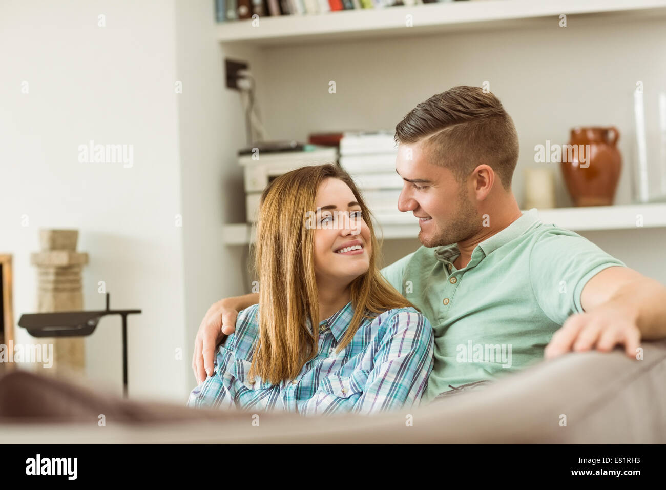 Cute couple relaxing on couch Stock Photo - Alamy