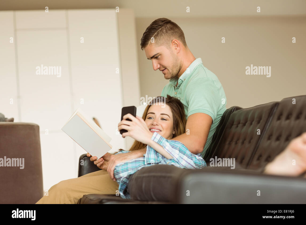 Cute couple relaxing on couch Stock Photo - Alamy