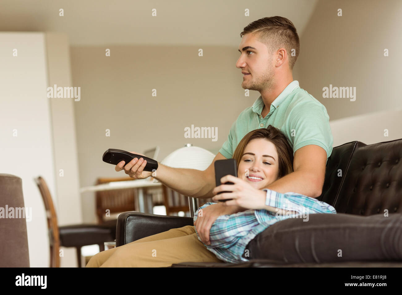 Cute couple relaxing on couch Stock Photo - Alamy