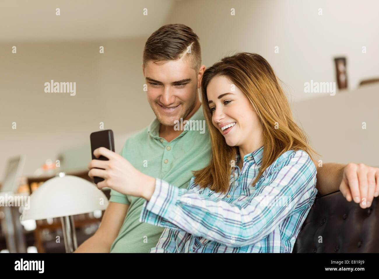 Cute couple relaxing on couch Stock Photo - Alamy