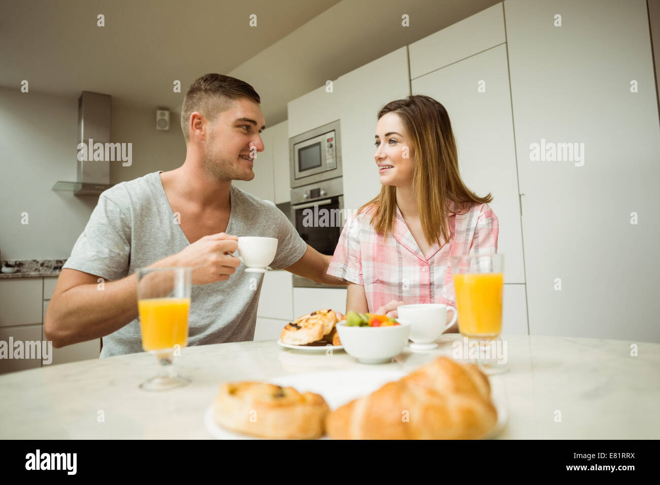 Cute couple having breakfast together Stock Photo - Alamy