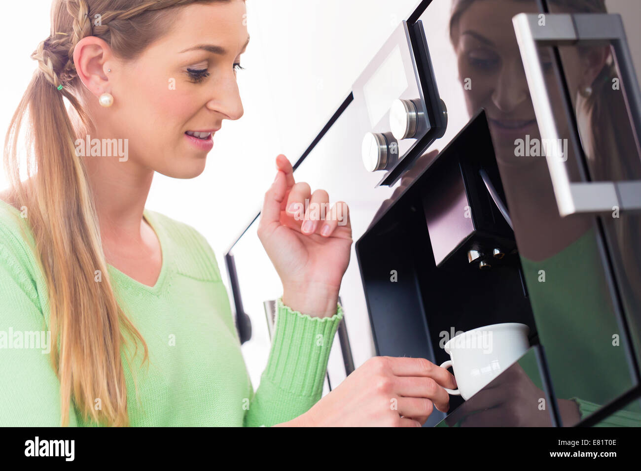 Woman using fully automatic coffee machine at home Stock Photo - Alamy