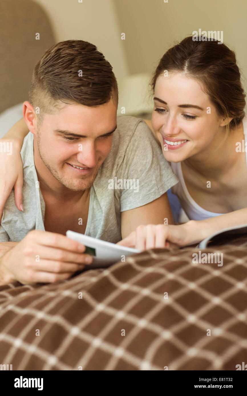 Couple reading newspaper in bed hi-res stock photography and images - Alamy