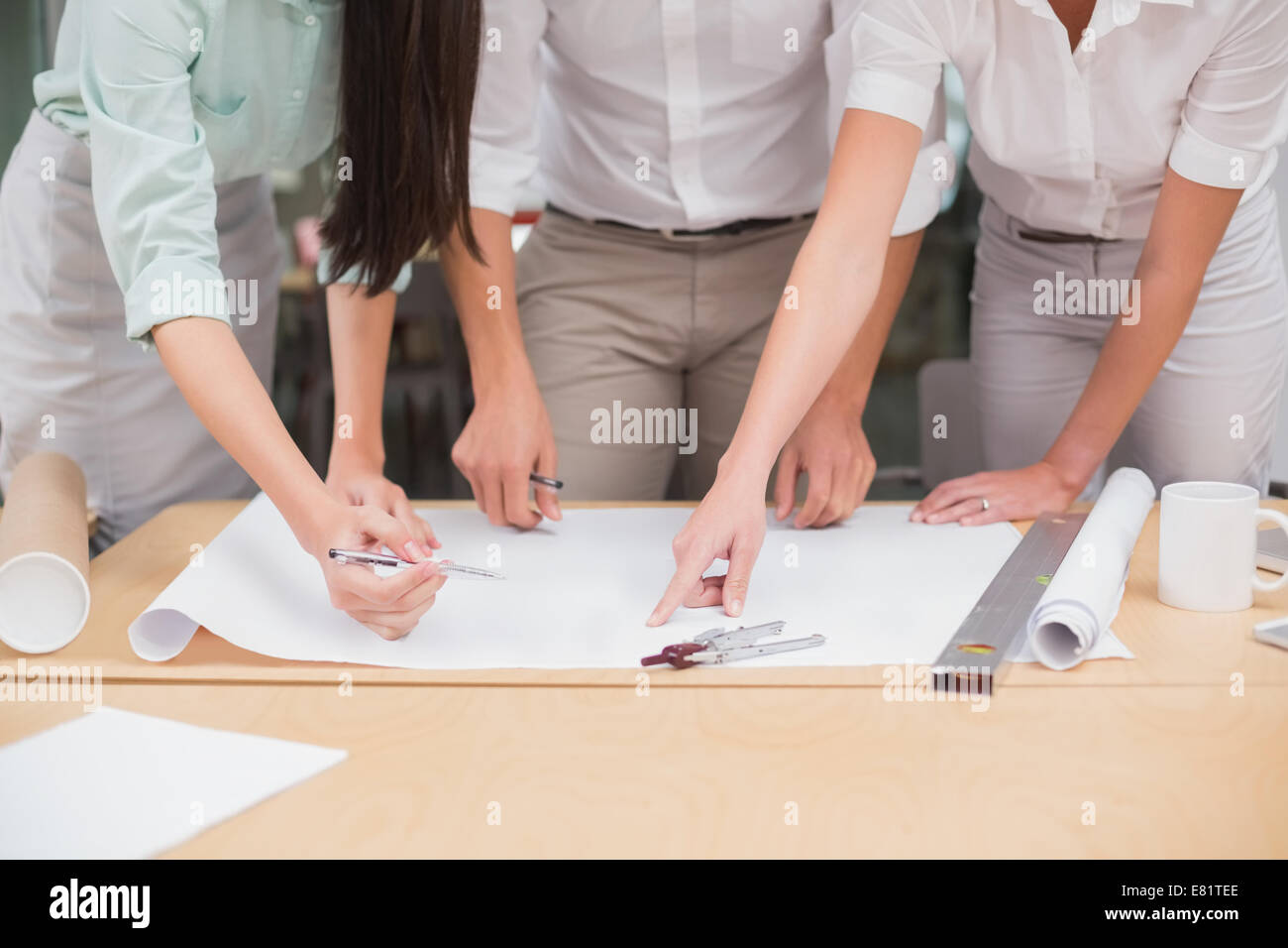 Architecture team working together at desk Stock Photo - Alamy