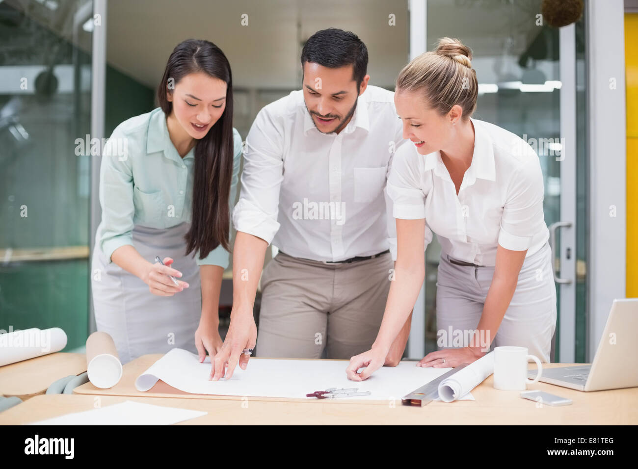 Architecture team working together at desk Stock Photo - Alamy