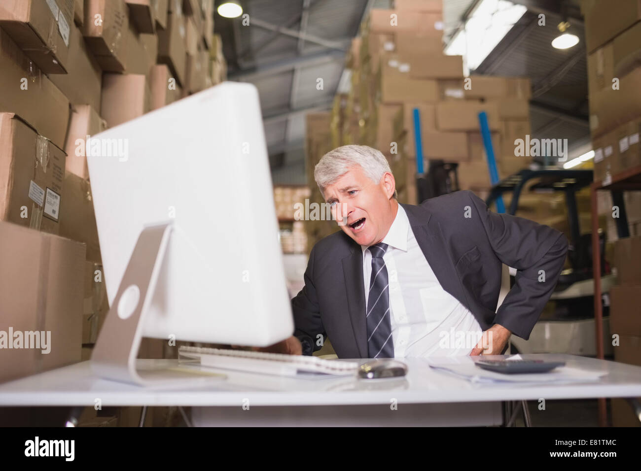 Warehouse manager using computer Stock Photo - Alamy