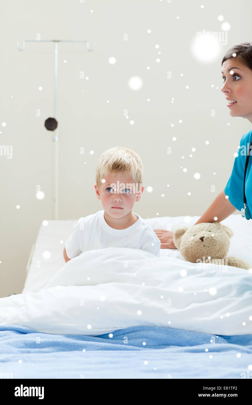 Composite image of portrait of a sick little boy on a hospital bed ...