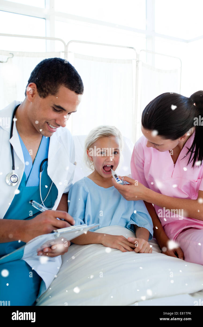 Composite image of young nurse taking her child patients temperature ...