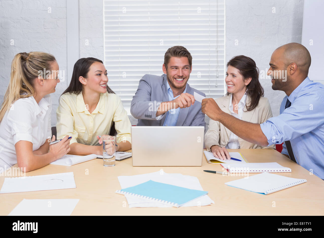 Businessman giving a credit card to his colleague Stock Photo - Alamy