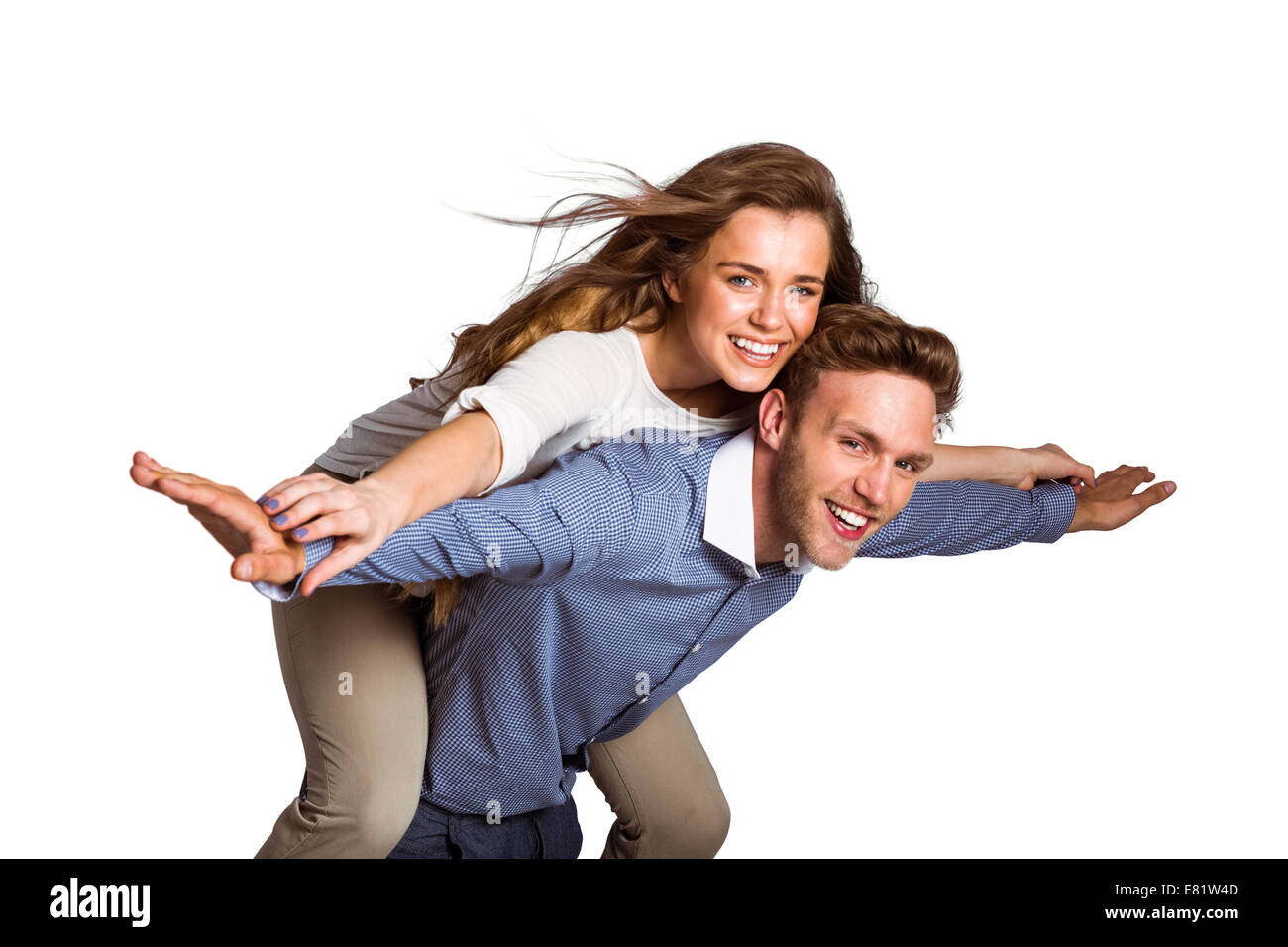 Smiling young man carrying woman Stock Photo - Alamy