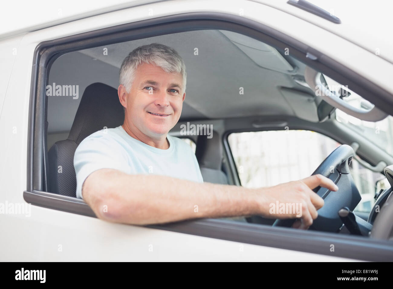 Smiling man driving van Stock Photo - Alamy