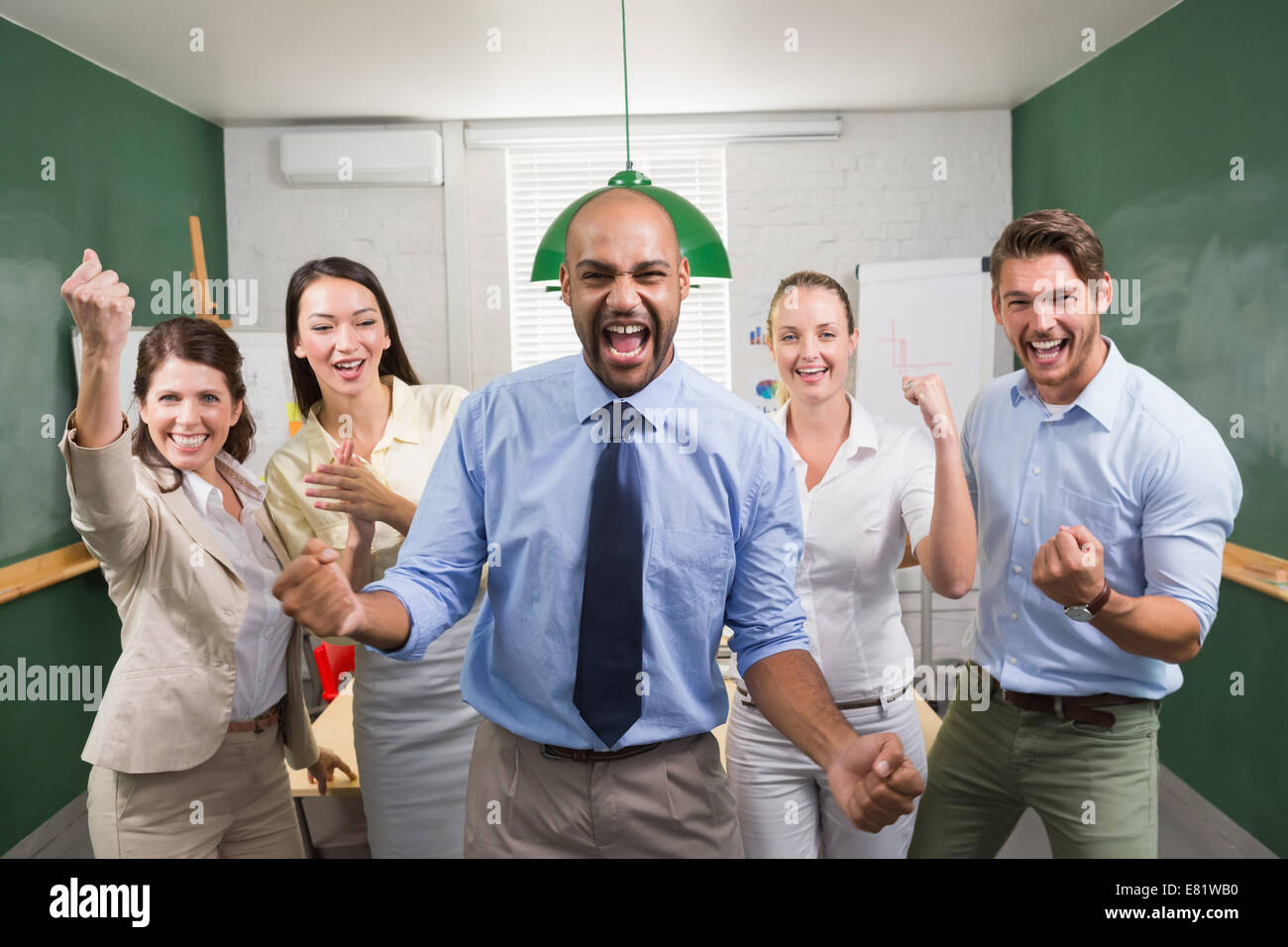 Excited business team cheering at camera Stock Photo - Alamy