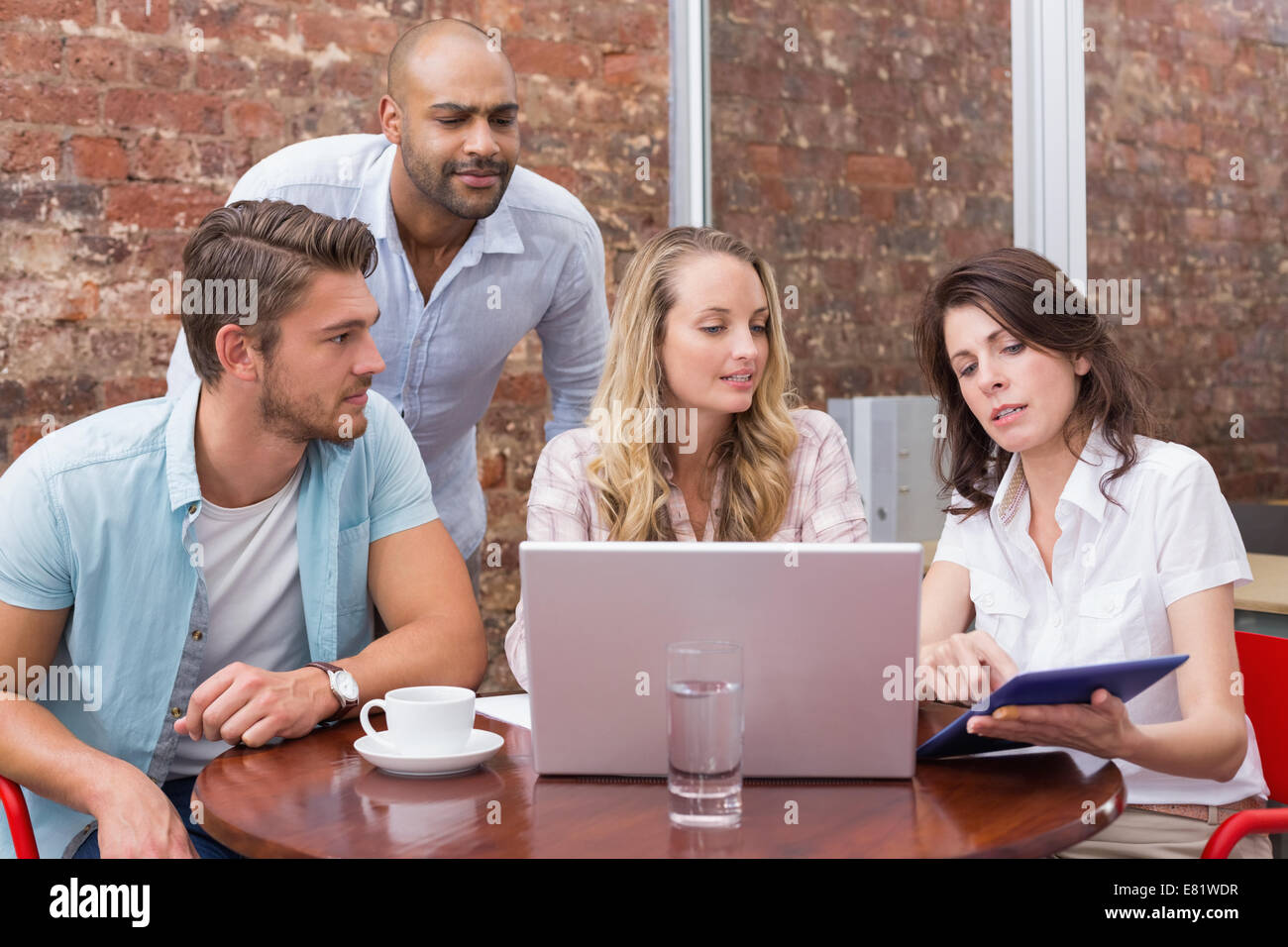 Business team talking and using tablet pc Stock Photo - Alamy