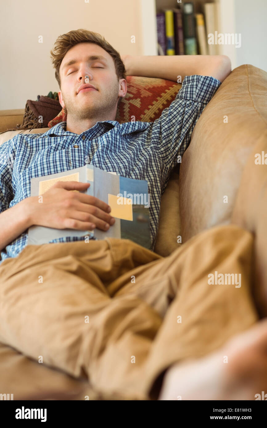 Young man napping on his couch Stock Photo - Alamy