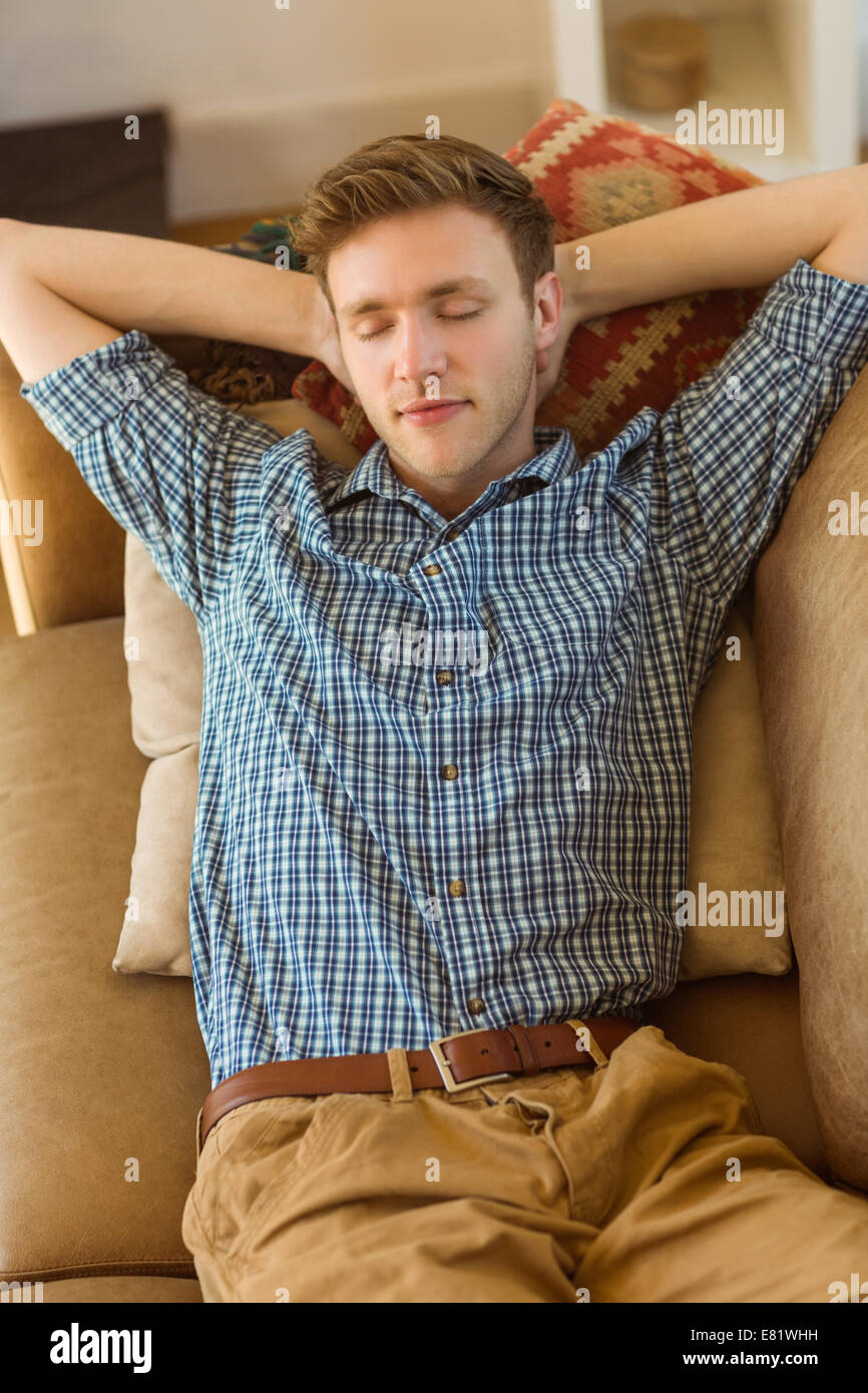 Young man napping on his couch Stock Photo - Alamy