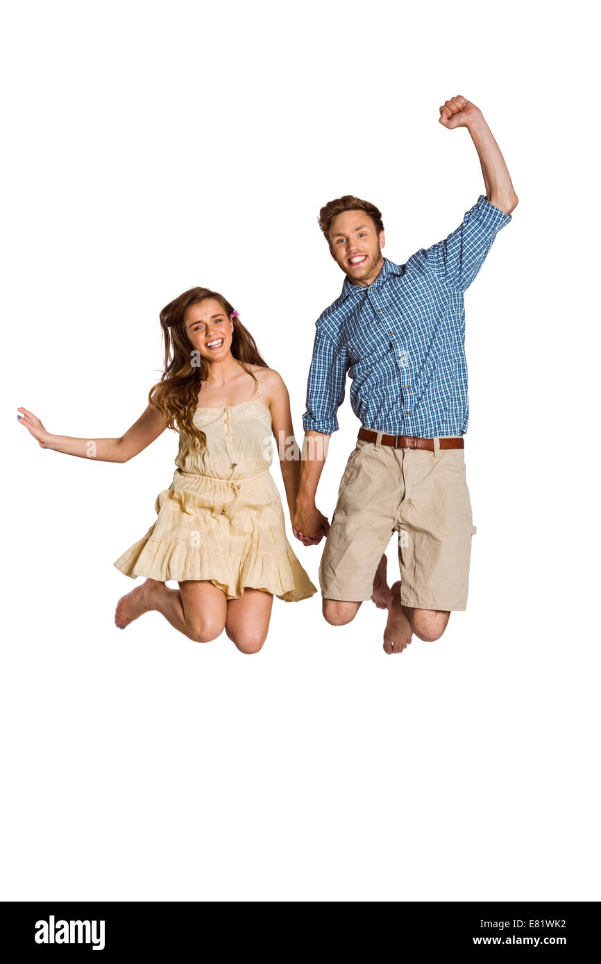 Cheerful young couple jumping Stock Photo - Alamy