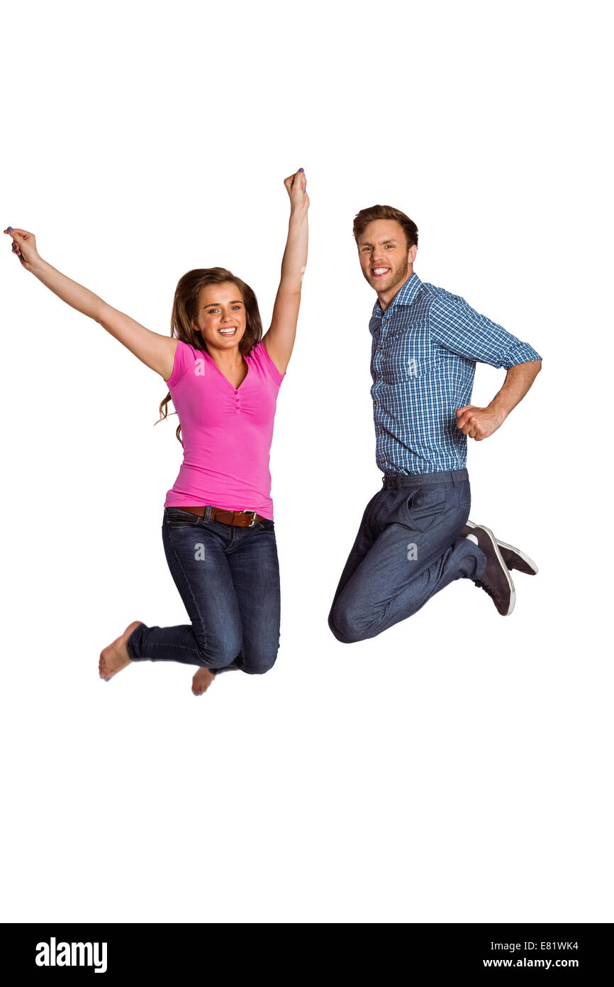 Cheerful young couple jumping Stock Photo - Alamy