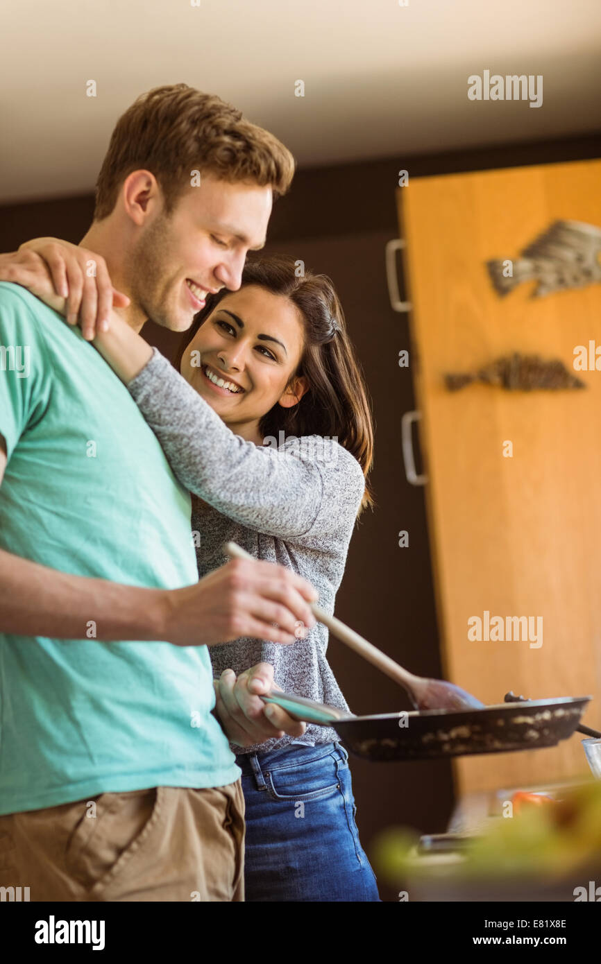 Cute couple preparing food together Stock Photo - Alamy