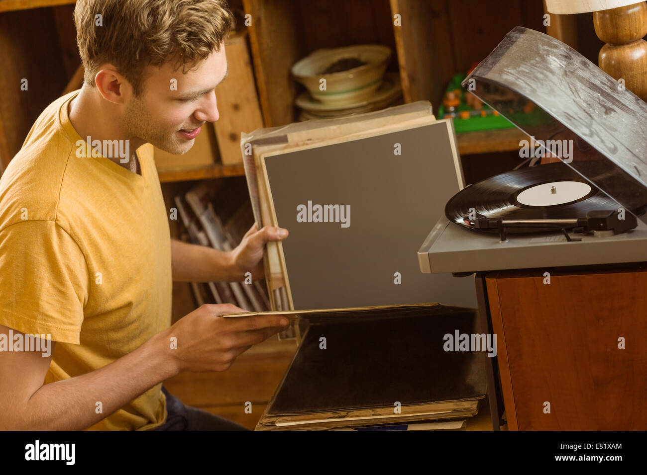 Young man looking at his vinyl collection Stock Photo - Alamy