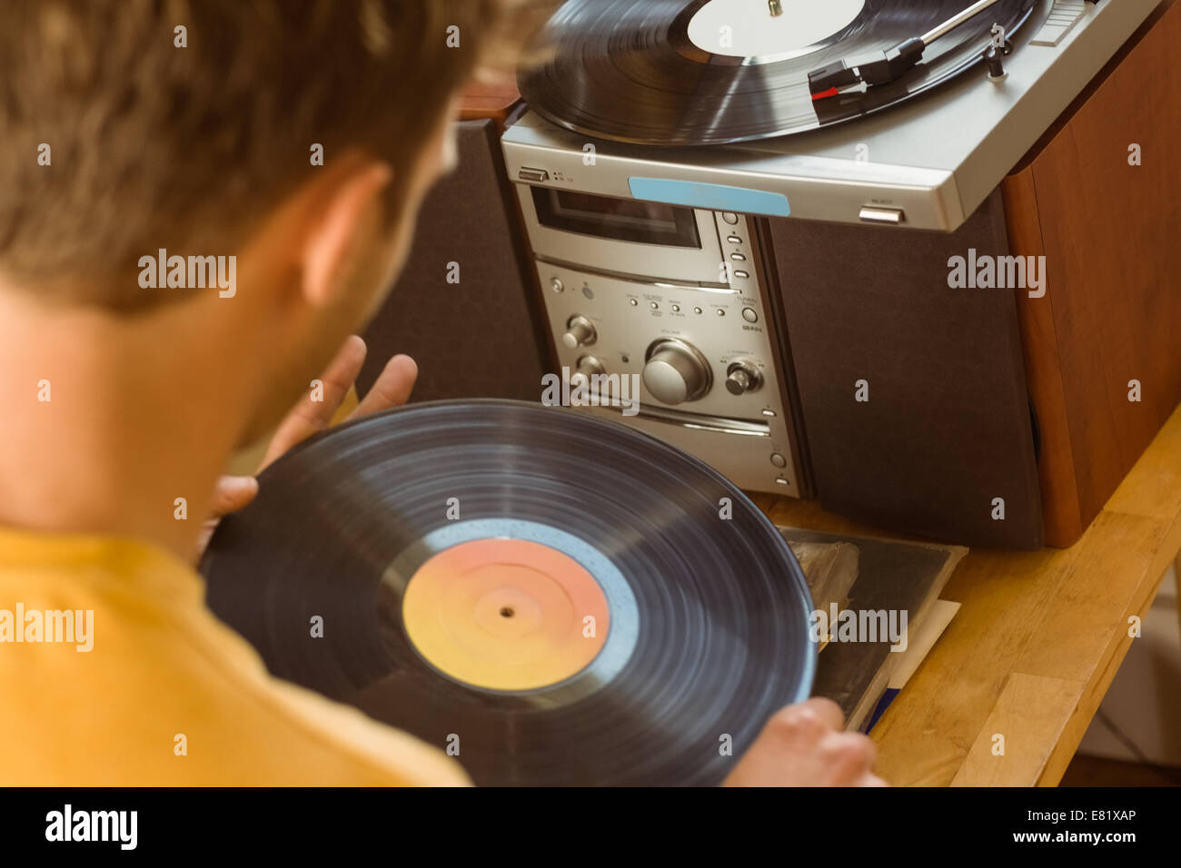 Young man looking at his vinyl collection Stock Photo - Alamy