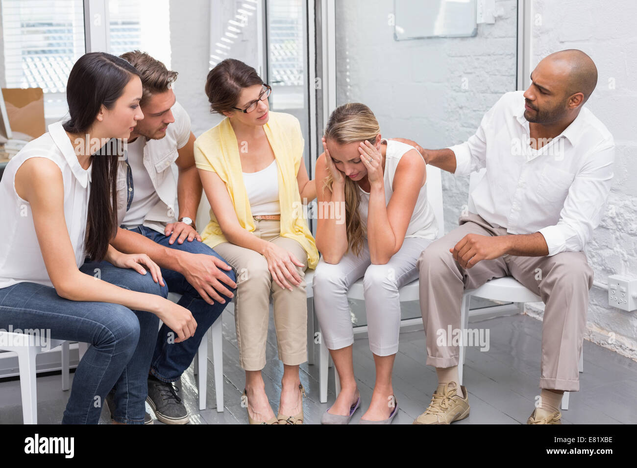 Business team sitting together supporting sad colleague Stock Photo - Alamy