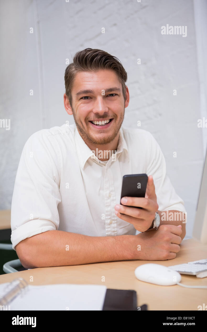 Businessman using mobile phone in office Stock Photo - Alamy