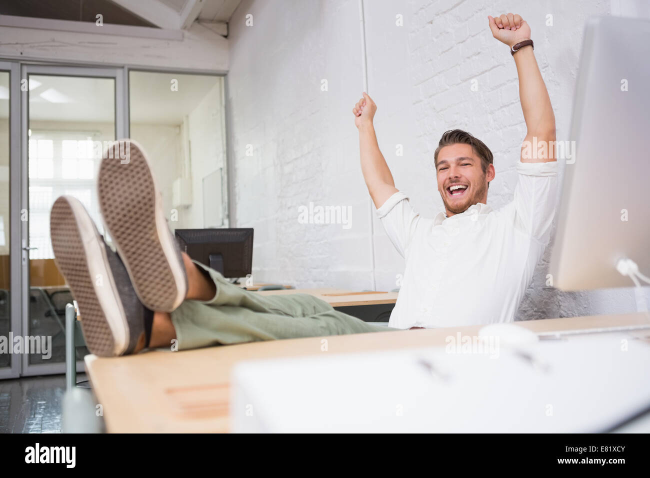 Cheerful businessman cheering in office Stock Photo - Alamy