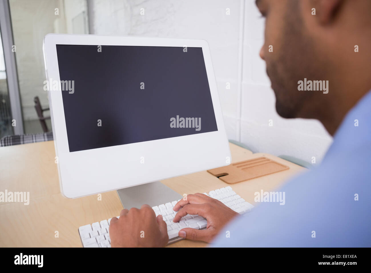Businessman using computer at desk Stock Photo - Alamy