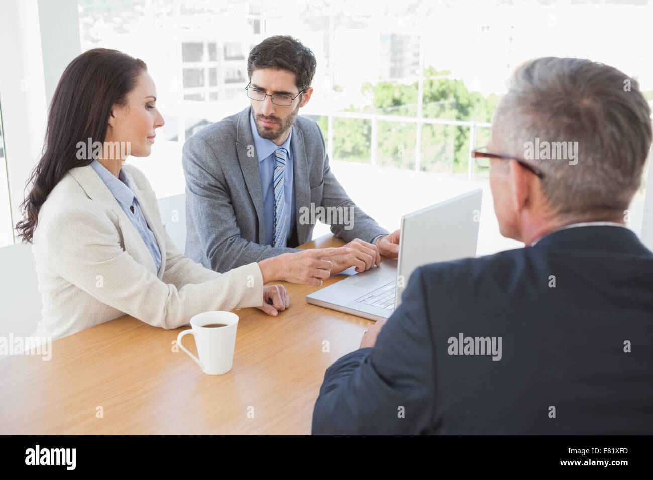 Co workers using laptop hi-res stock photography and images - Alamy
