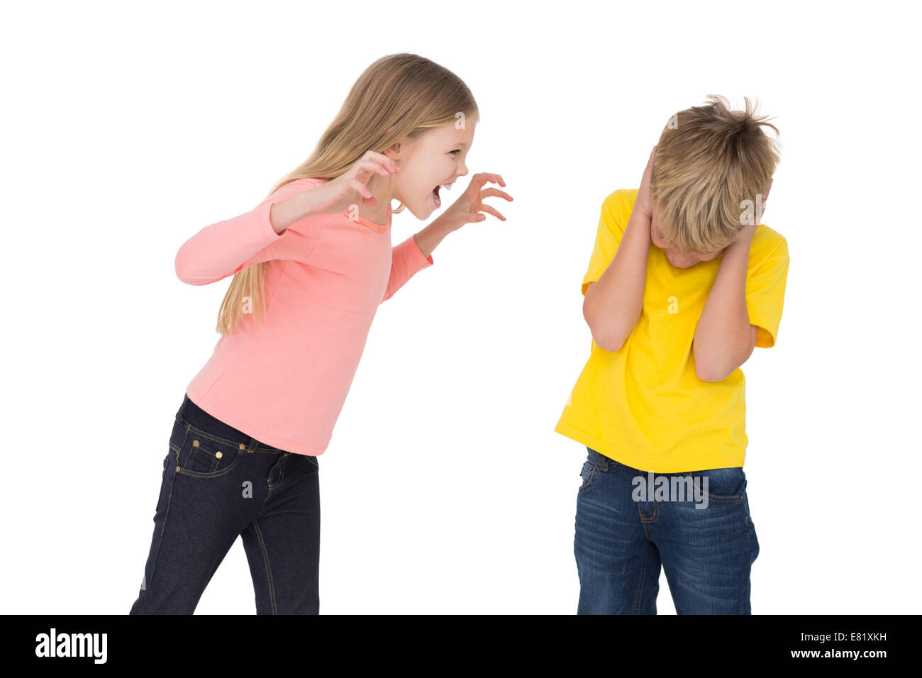 Little girl scaring her brother Stock Photo - Alamy