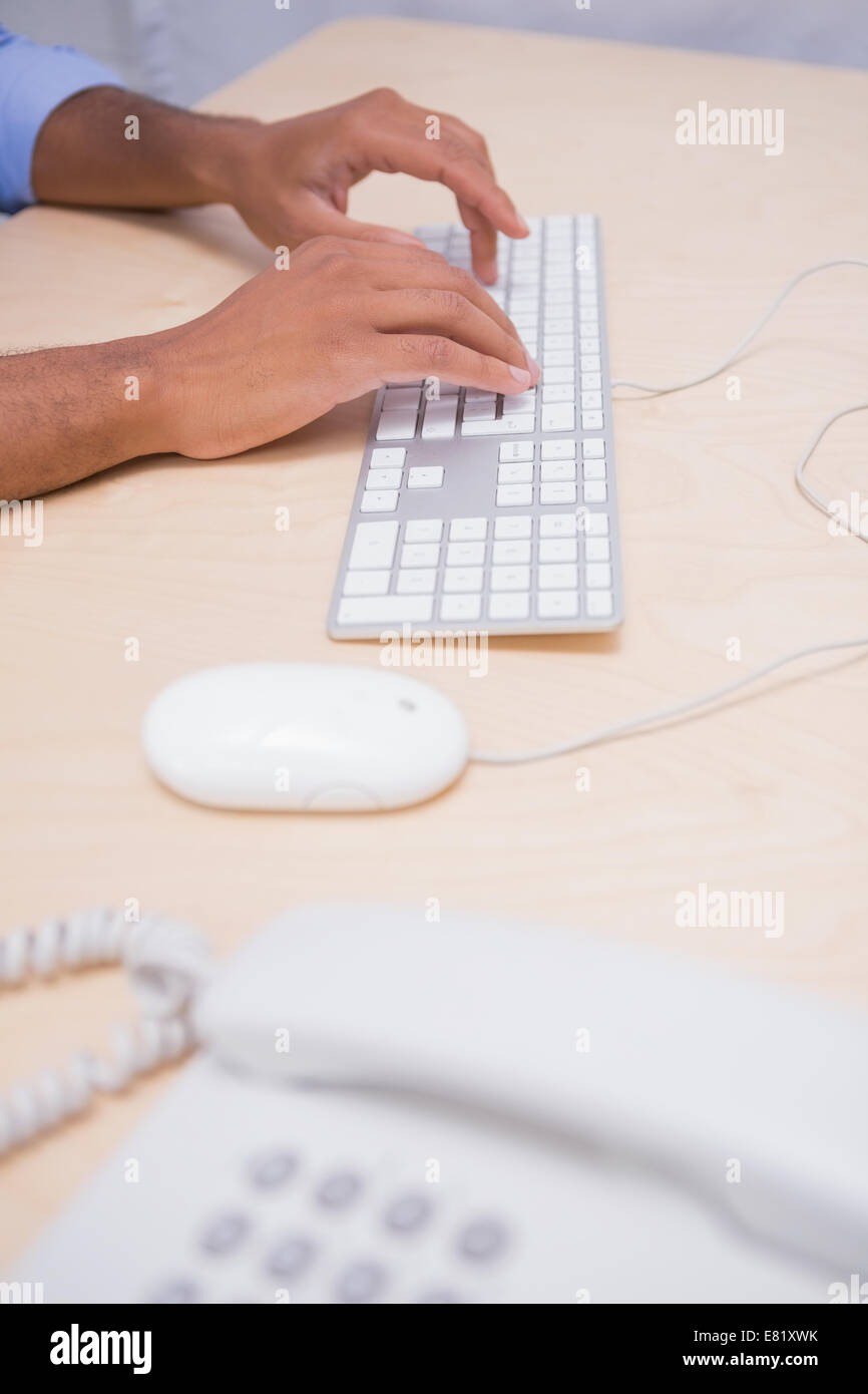 Hands using keyboard at desk Stock Photo - Alamy