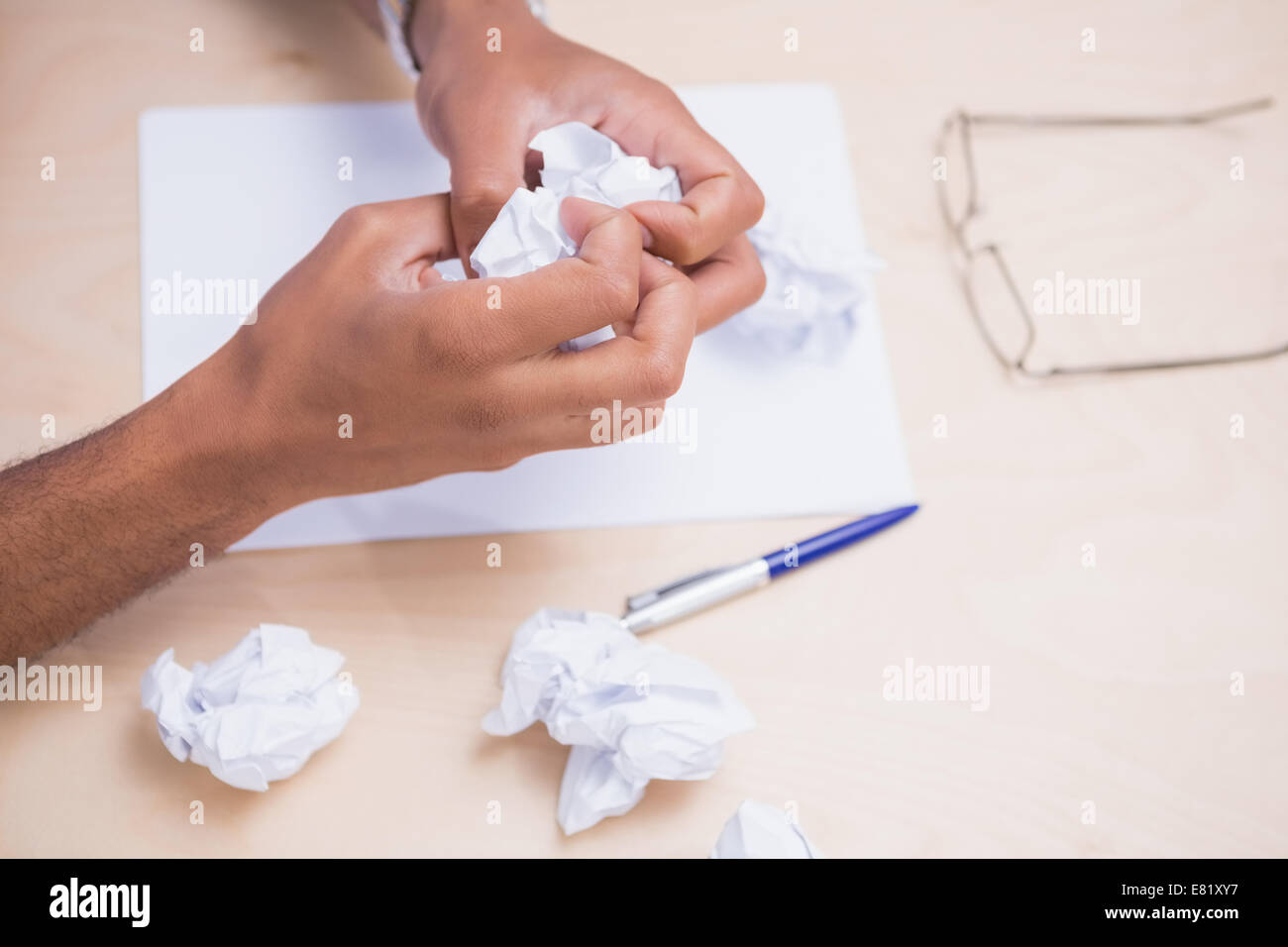 Hands crumpling papers on desk Stock Photo - Alamy