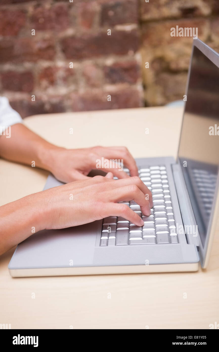 Hands using laptop at office desk Stock Photo - Alamy