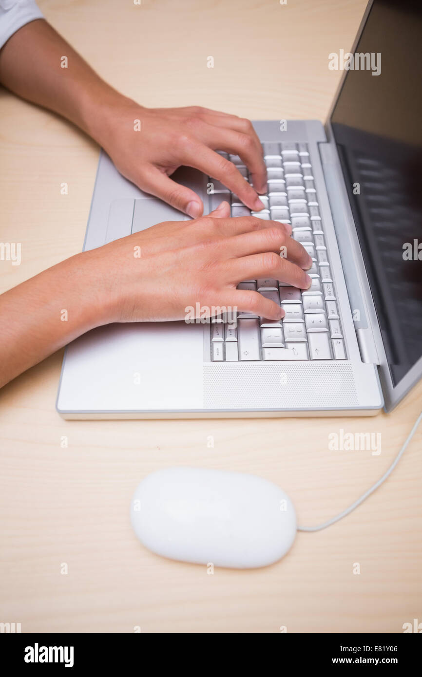 Hands using laptop at desk Stock Photo - Alamy
