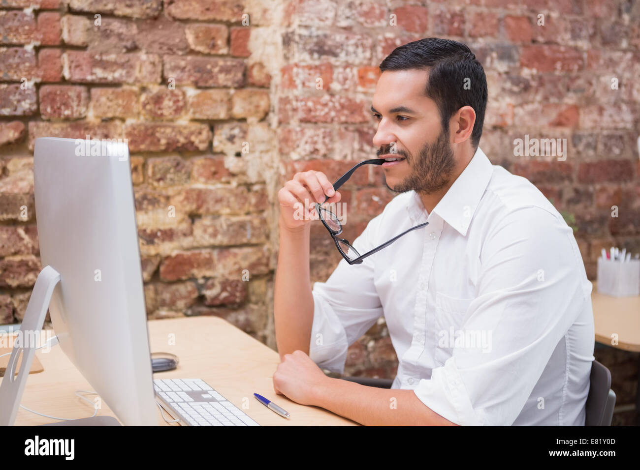 Businessman using computer at desk Stock Photo - Alamy