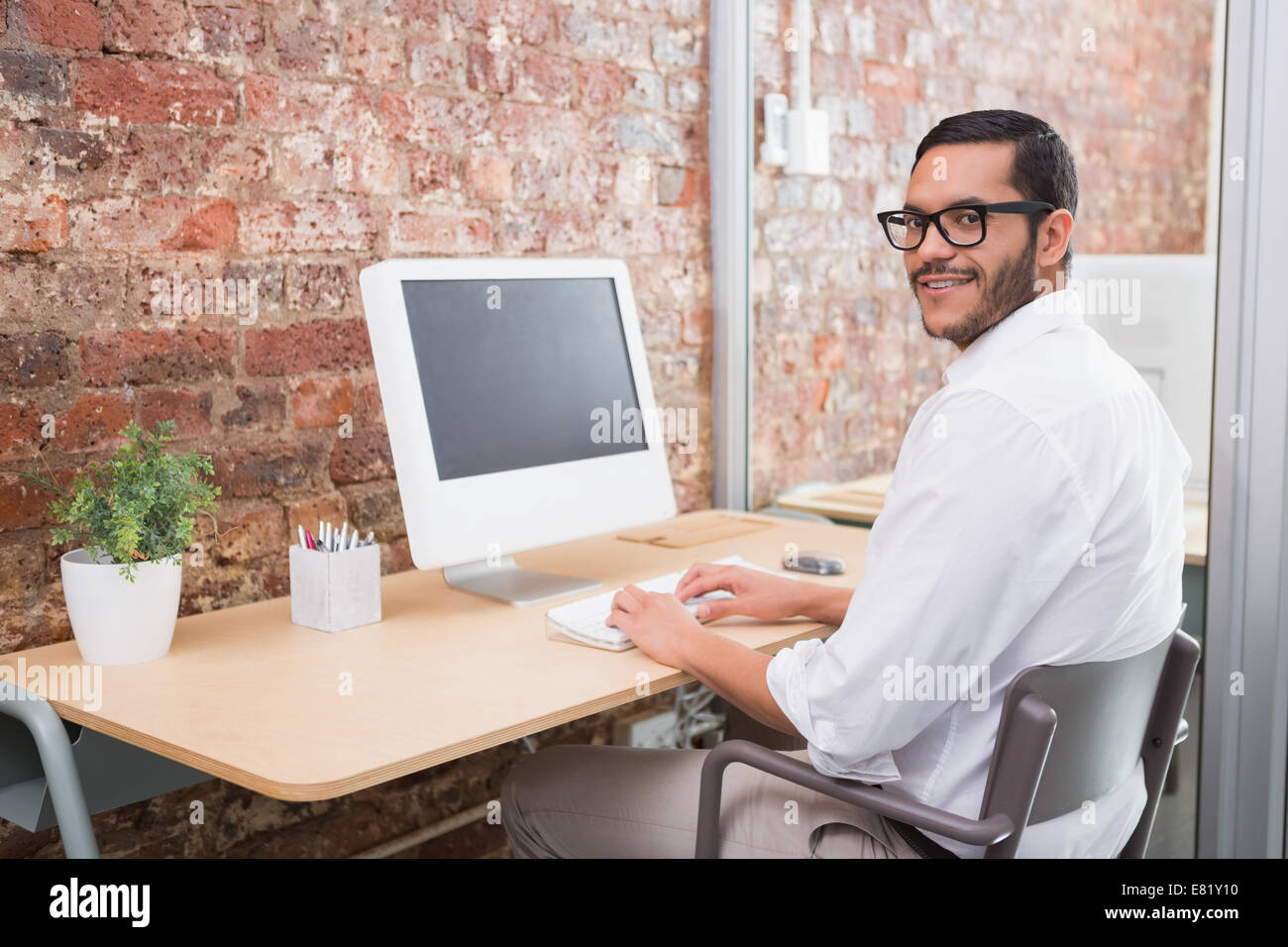 Businessman using computer at desk Stock Photo - Alamy