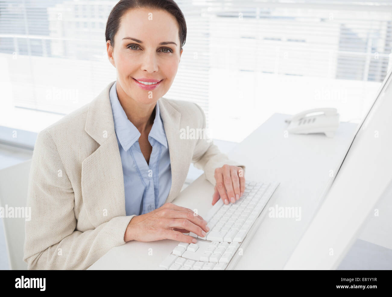 Businesswoman using her work computer Stock Photo - Alamy