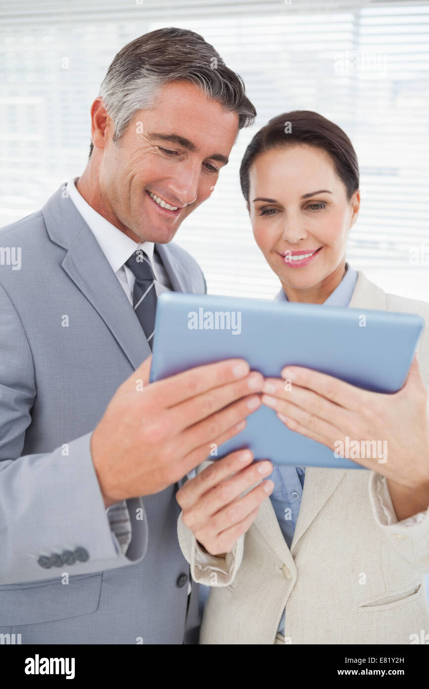 Business team using a tablet pc Stock Photo - Alamy