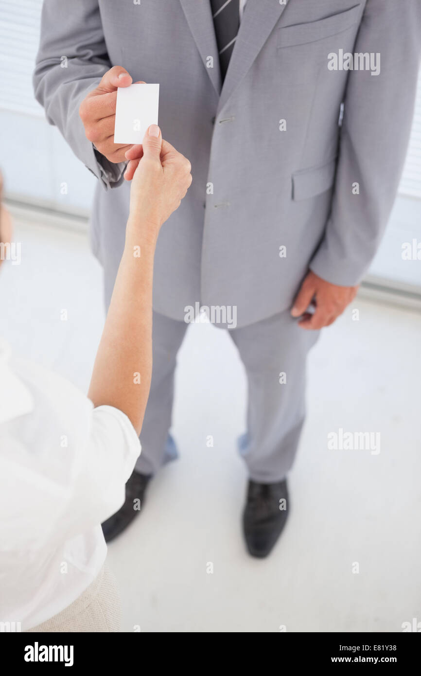 Businesswoman offering a client her business card Stock Photo - Alamy