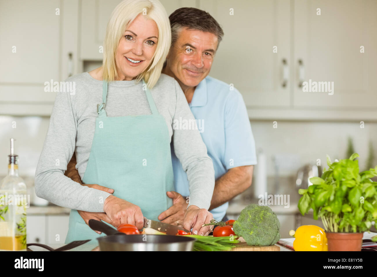 Happy mature couple making dinner together Stock Photo - Alamy