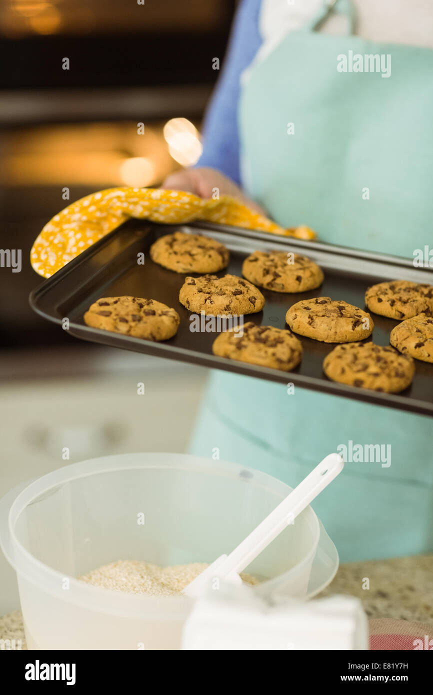 Woman showing tray of fresh cookies Stock Photo - Alamy
