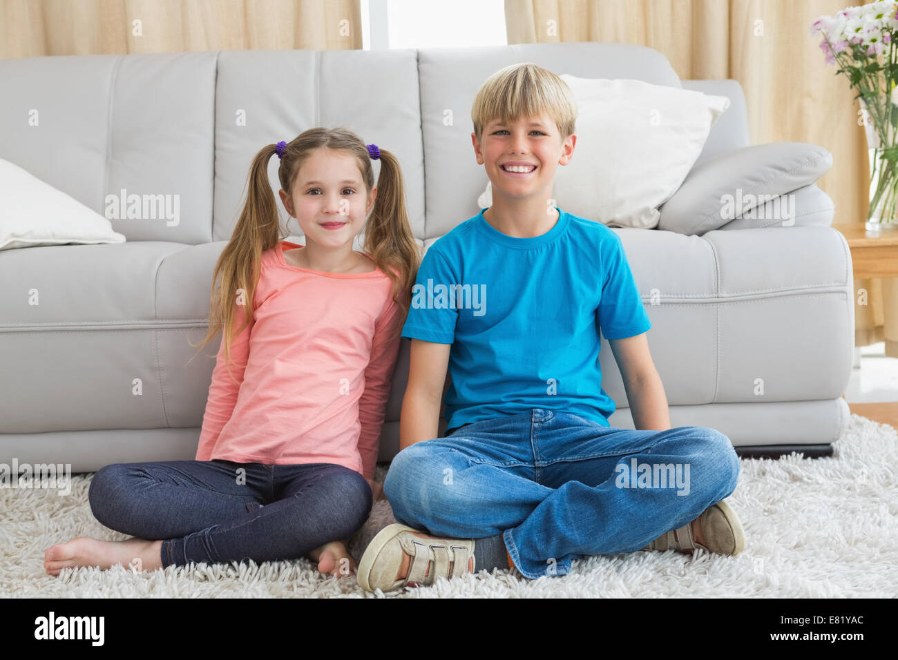 Happy siblings smiling at camera together Stock Photo - Alamy