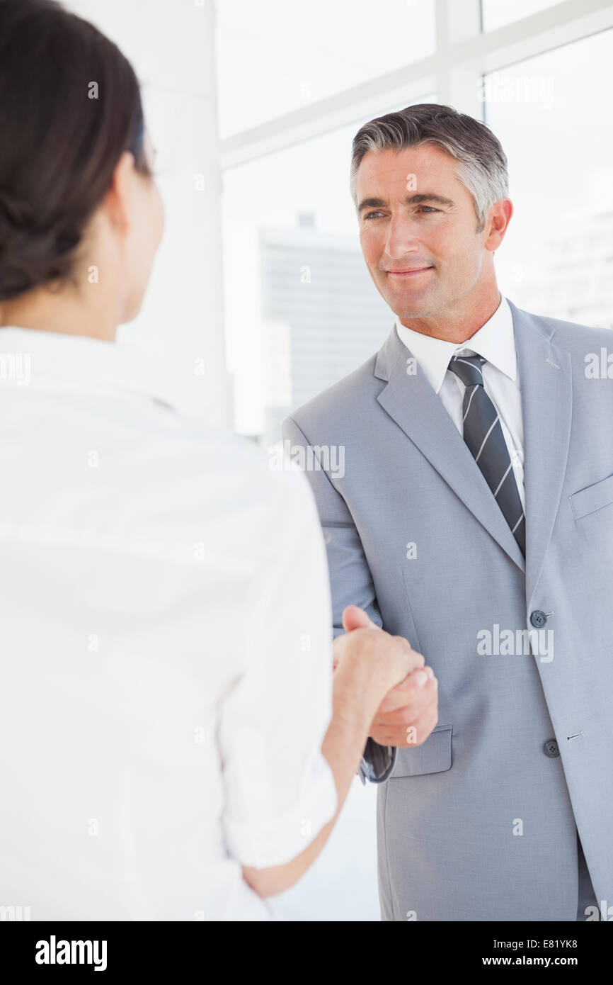 Businessman shaking co workers hand Stock Photo - Alamy