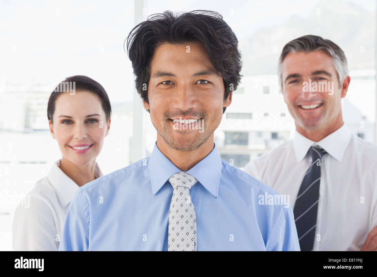 Happy business people looking at camera Stock Photo - Alamy