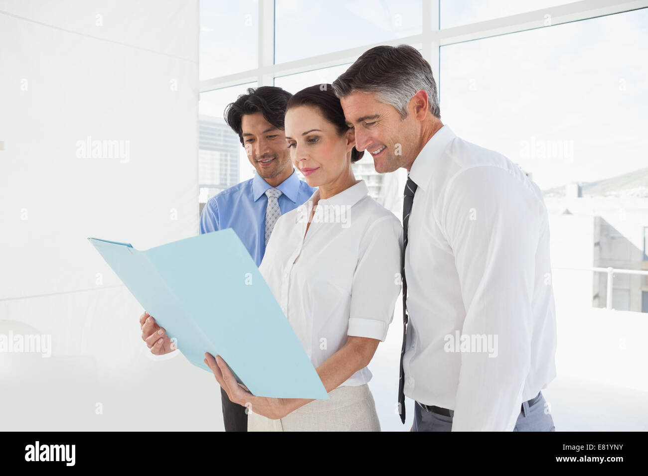 Business team looking over files Stock Photo - Alamy