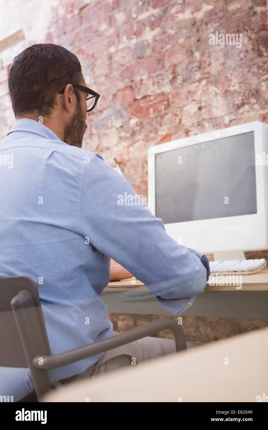 Businessman using computer at desk Stock Photo - Alamy