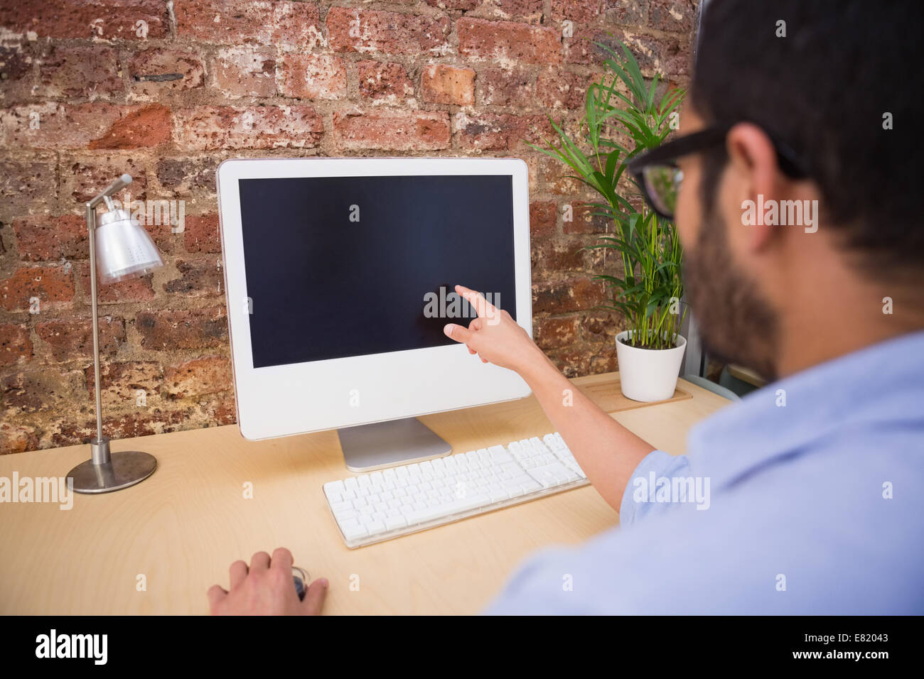 Businessman using computer at desk Stock Photo - Alamy