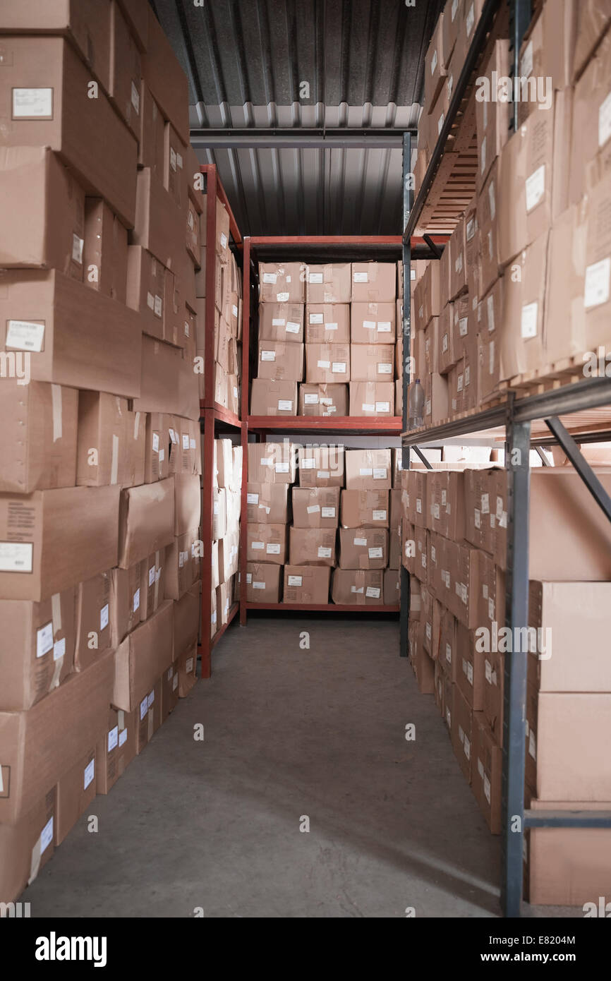 Shelves with boxes in warehouse Stock Photo - Alamy