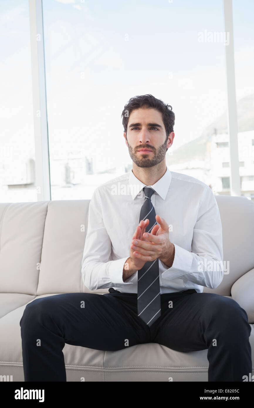 Smart dressed man sitting down hi-res stock photography and images - Alamy