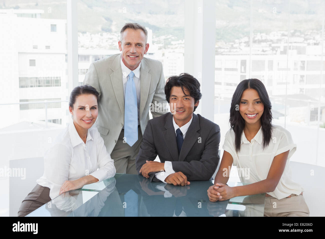 Smiling business team in an office Stock Photo - Alamy